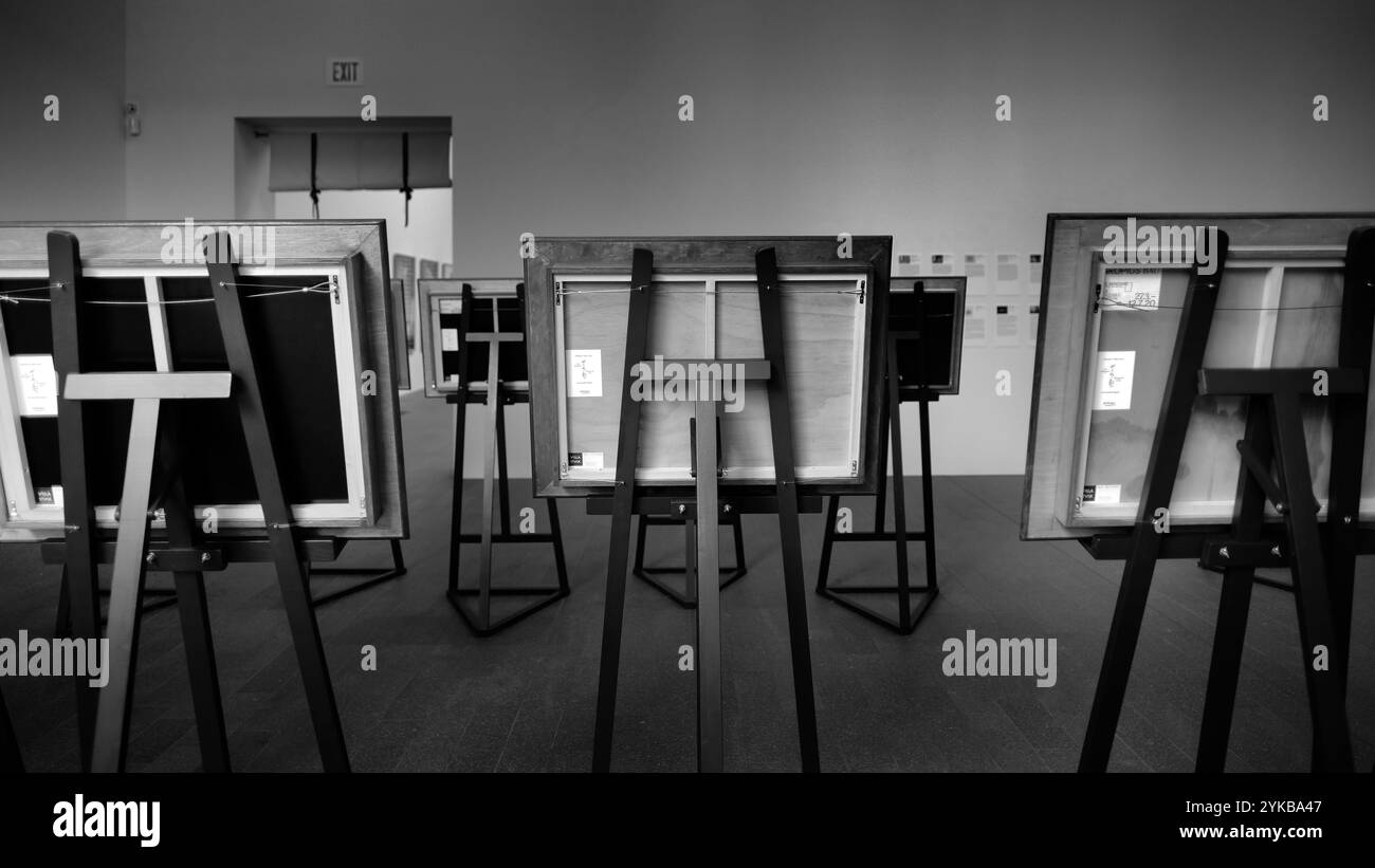 Monochrome image of wooden easels at a museum art exhibit seen from ...