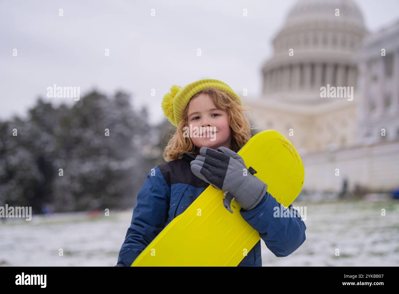 Winter Kids face. Kid play with Winter snowboard. First Winter snow ...