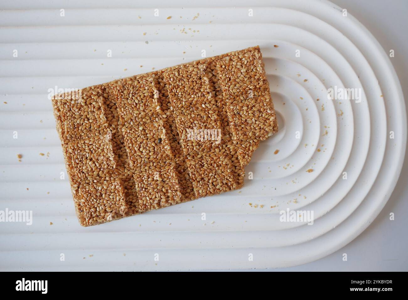 Enjoy a Crunchy Sesame Snack Bar beautifully presented on a stylish ...