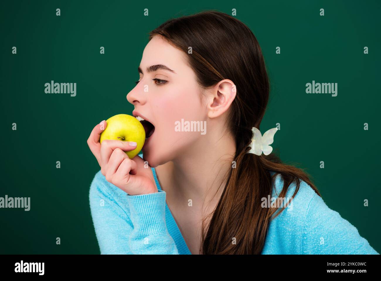 Student girl eat apple in school class. School teenager girl in middle ...