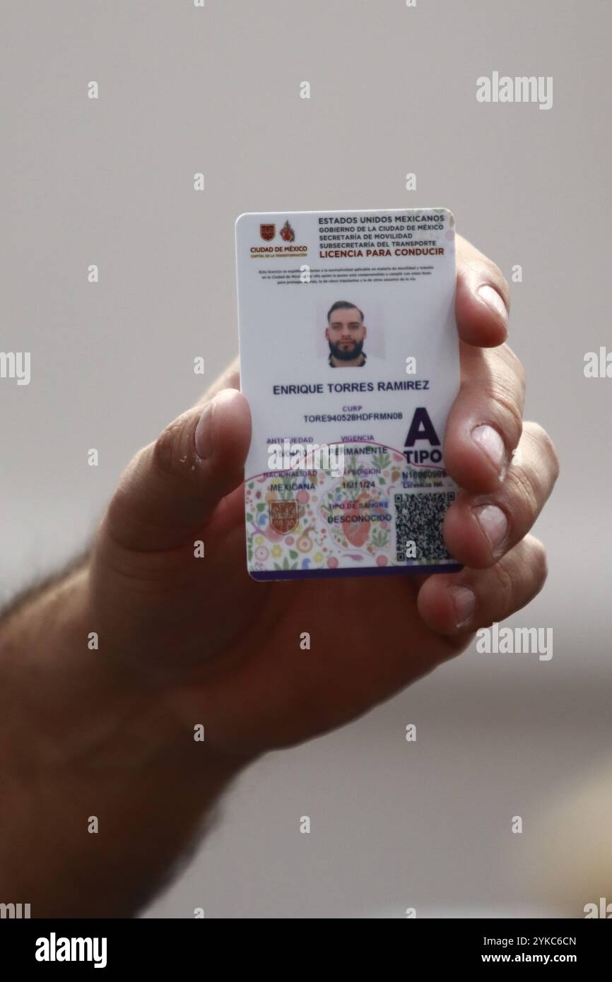 Non Exclusive: A person shows his new permanent driver's license after ...