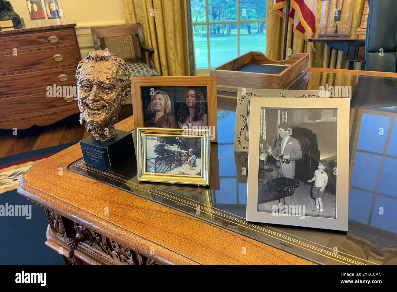 Photos and a bust of Franklin D. Roosevelt are displayed on a replica ...