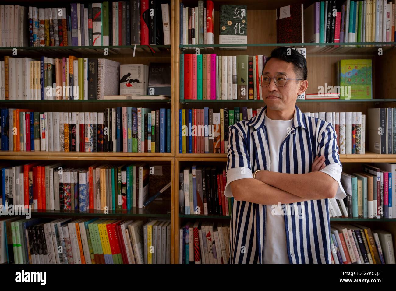 Yu Miao, owner of JF Books, poses for a photograph in his bookstore in Washington, Thursday, Oct ...