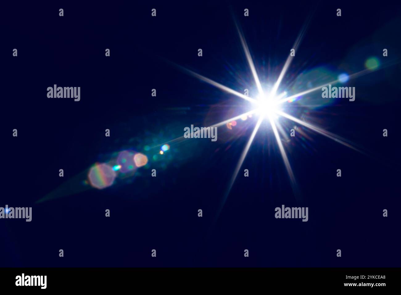 Bright shining light illuminating dark space with lens flare effects ...