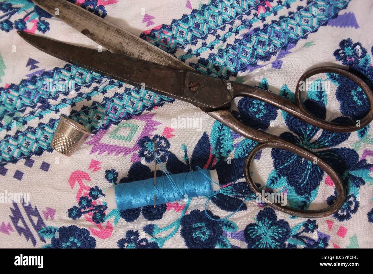 Vintage Embroidered Fabric With Spool of Blue Thread and Thimble Stock ...