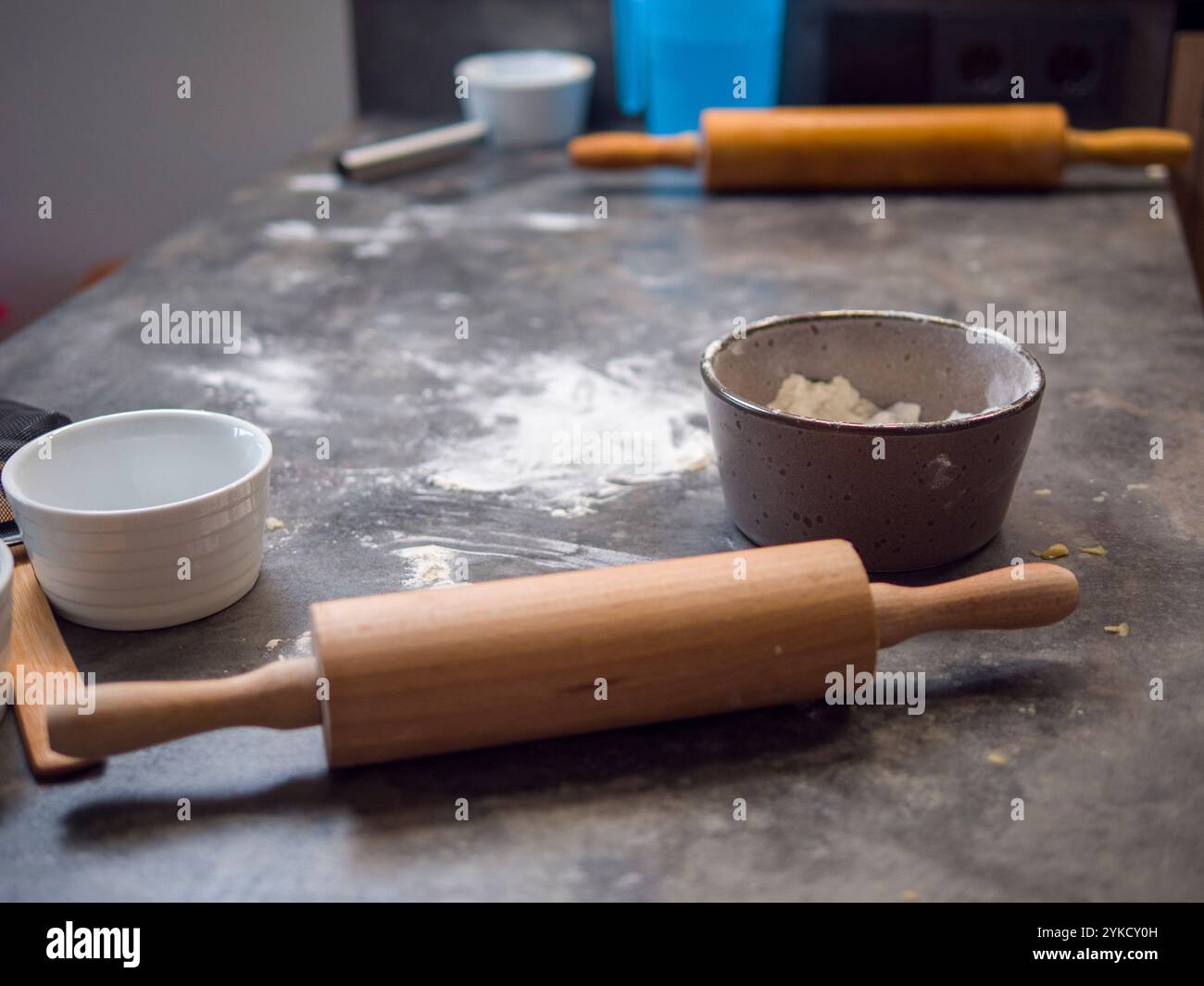 Cozy kitchen counter with rolling pins, bowls, and flour creating ...