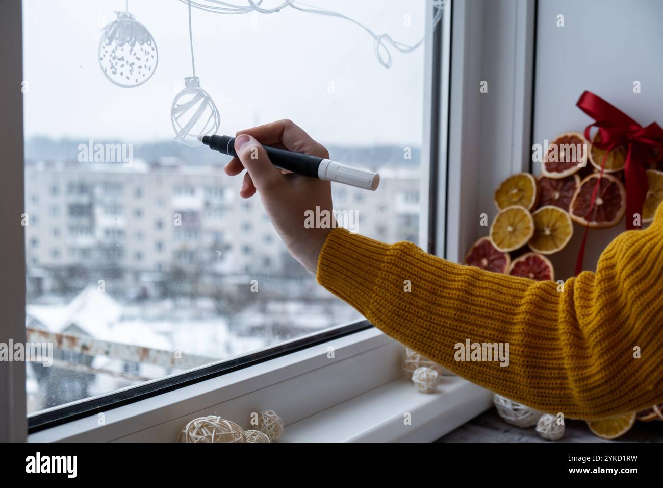 Creative enthusiastic unrecognizable woman in sweater paint window with ...