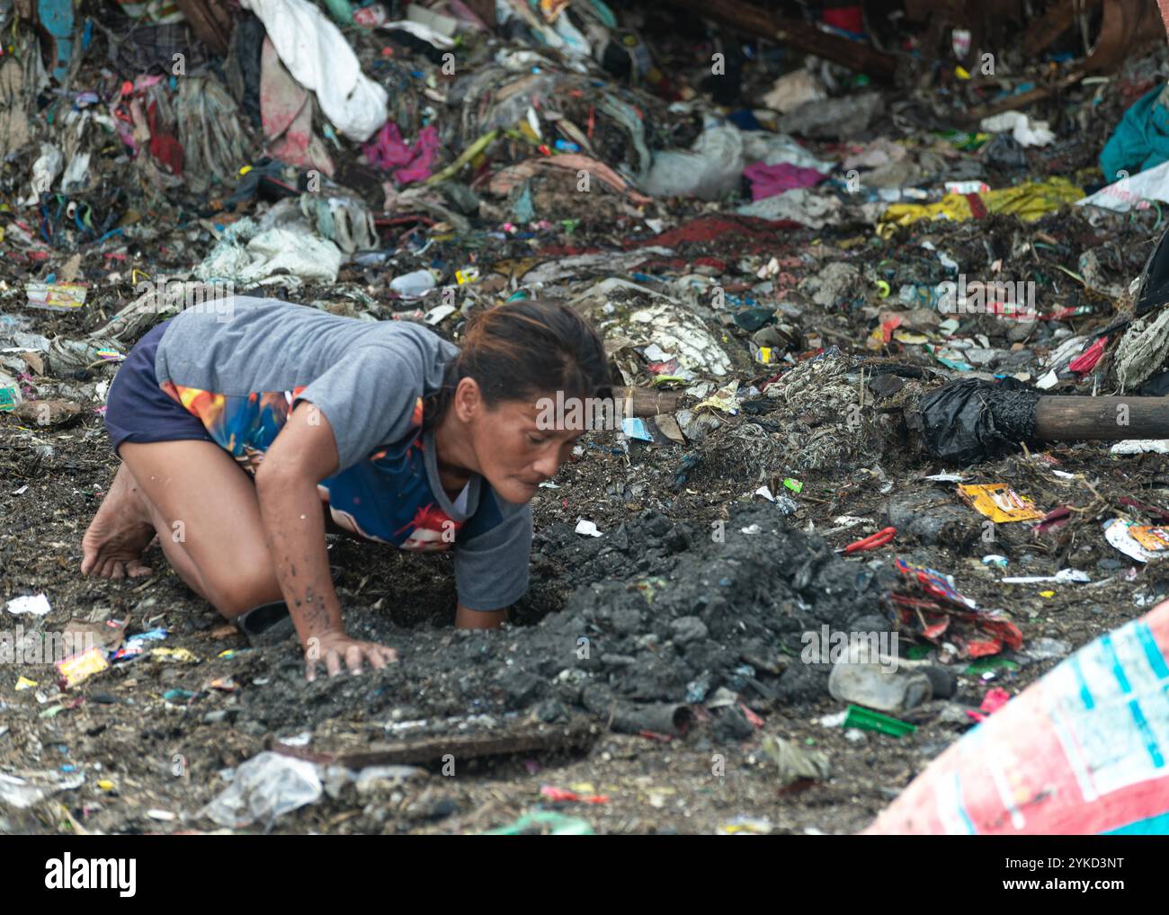 November 18, 2024, Manila, Ncr, Philippines: A resident digs a hole to ...