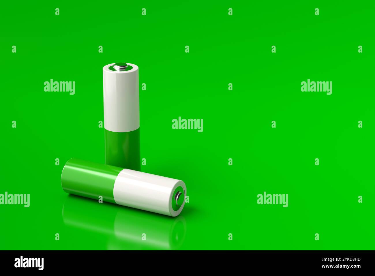Two cylindrical batteries lying on a reflective green surface ...