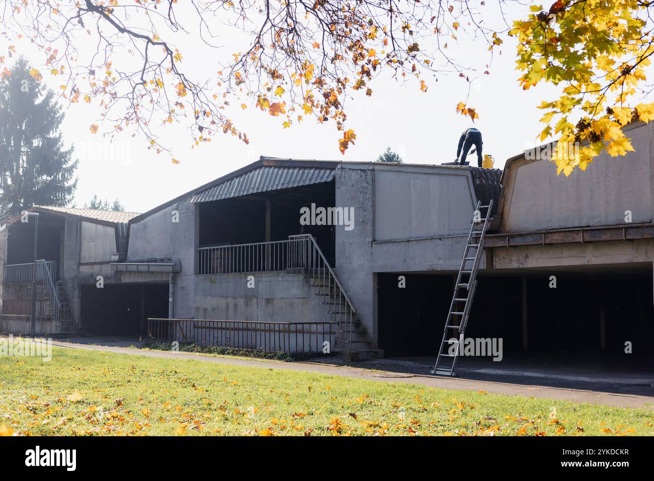 Unknown person heating roof isolation with a torch as a repair above ...