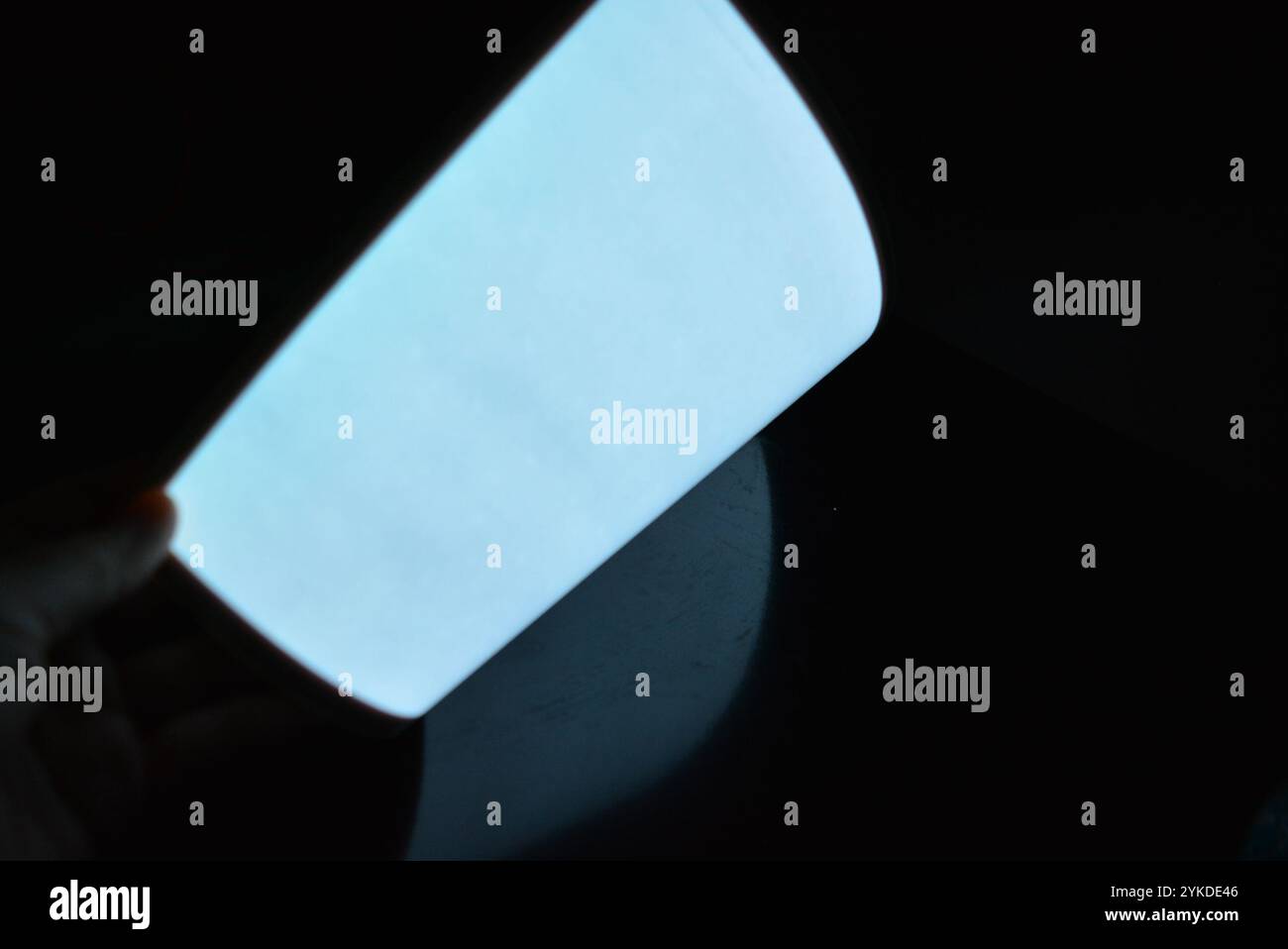 Bright glowing electroluminescent flexible paper twisted into an ...