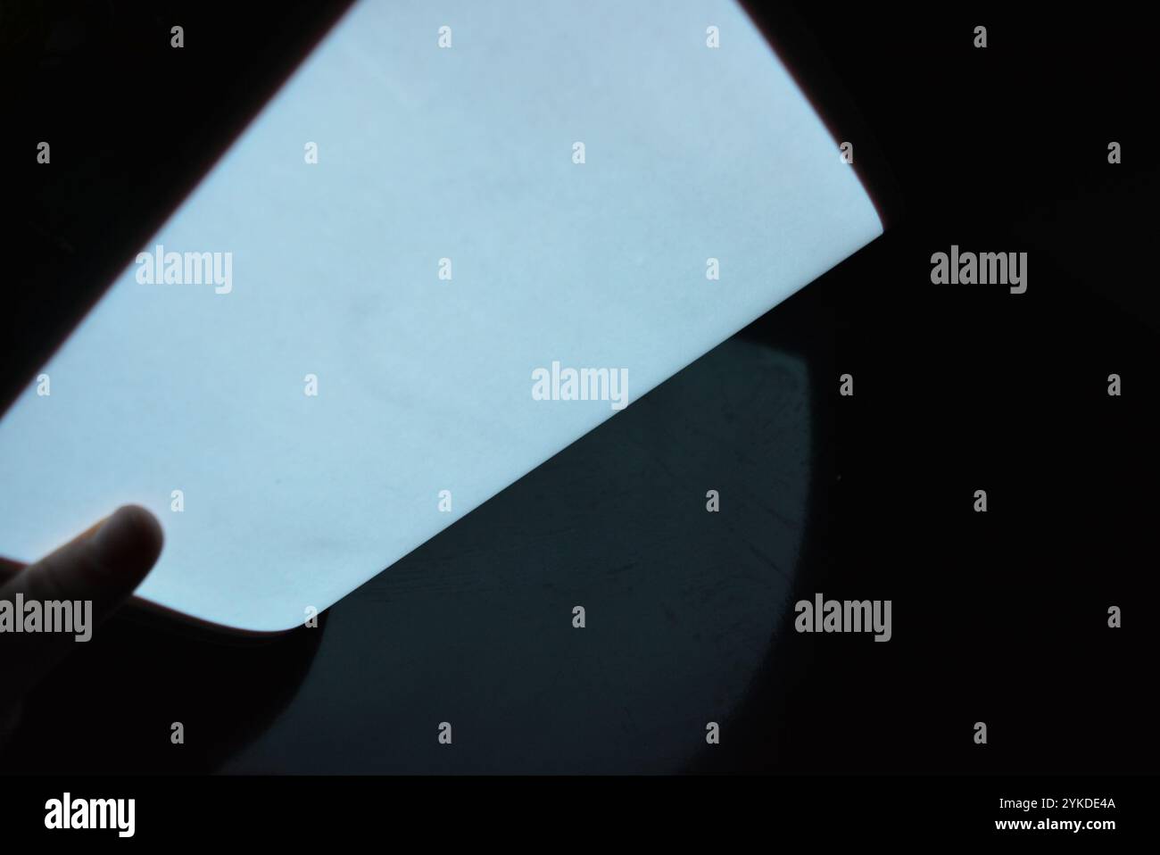 Bright glowing electroluminescent flexible paper twisted into an ...