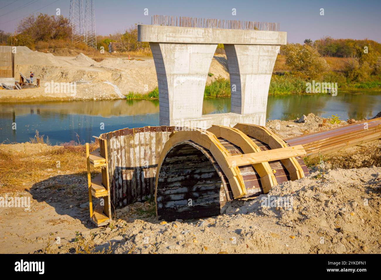 Wooden arch molds for bridge, large modern gray concrete pillar in ...