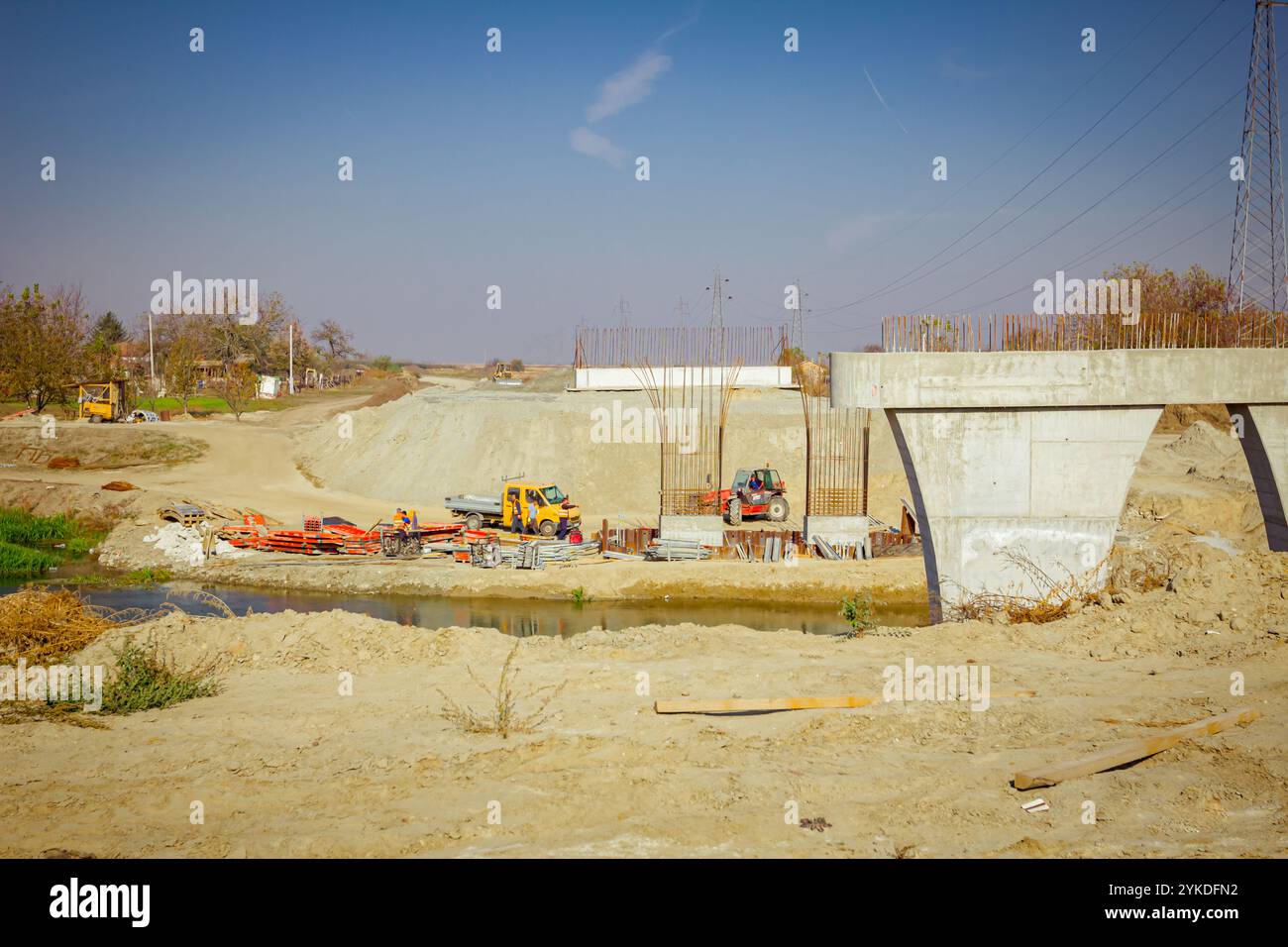 Large modern gray concrete bridge pillar in foundation surrounded by ...