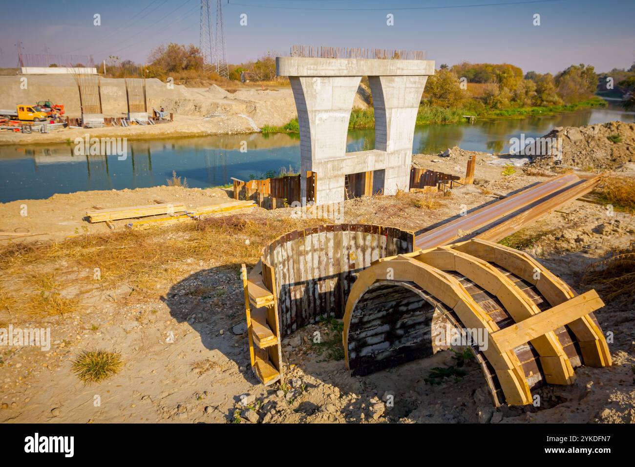 Wooden arch molds for bridge, large modern gray concrete pillar in ...