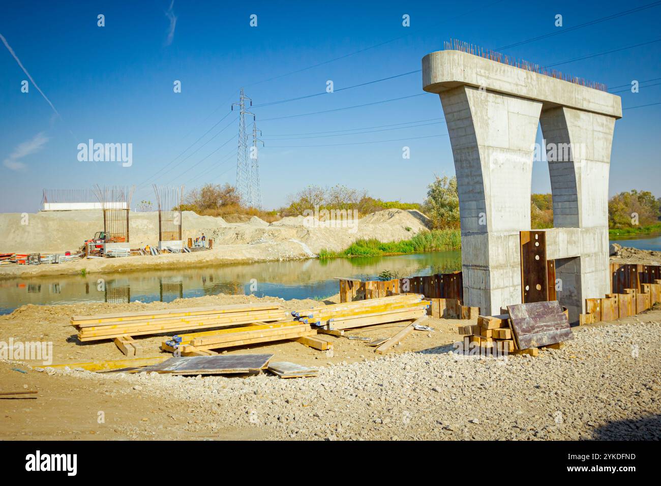 Large modern gray concrete pillar in foundation surrounded by metal ...
