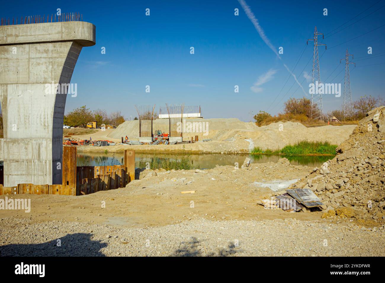 Large modern gray concrete bridge pillar in foundation surrounded by ...