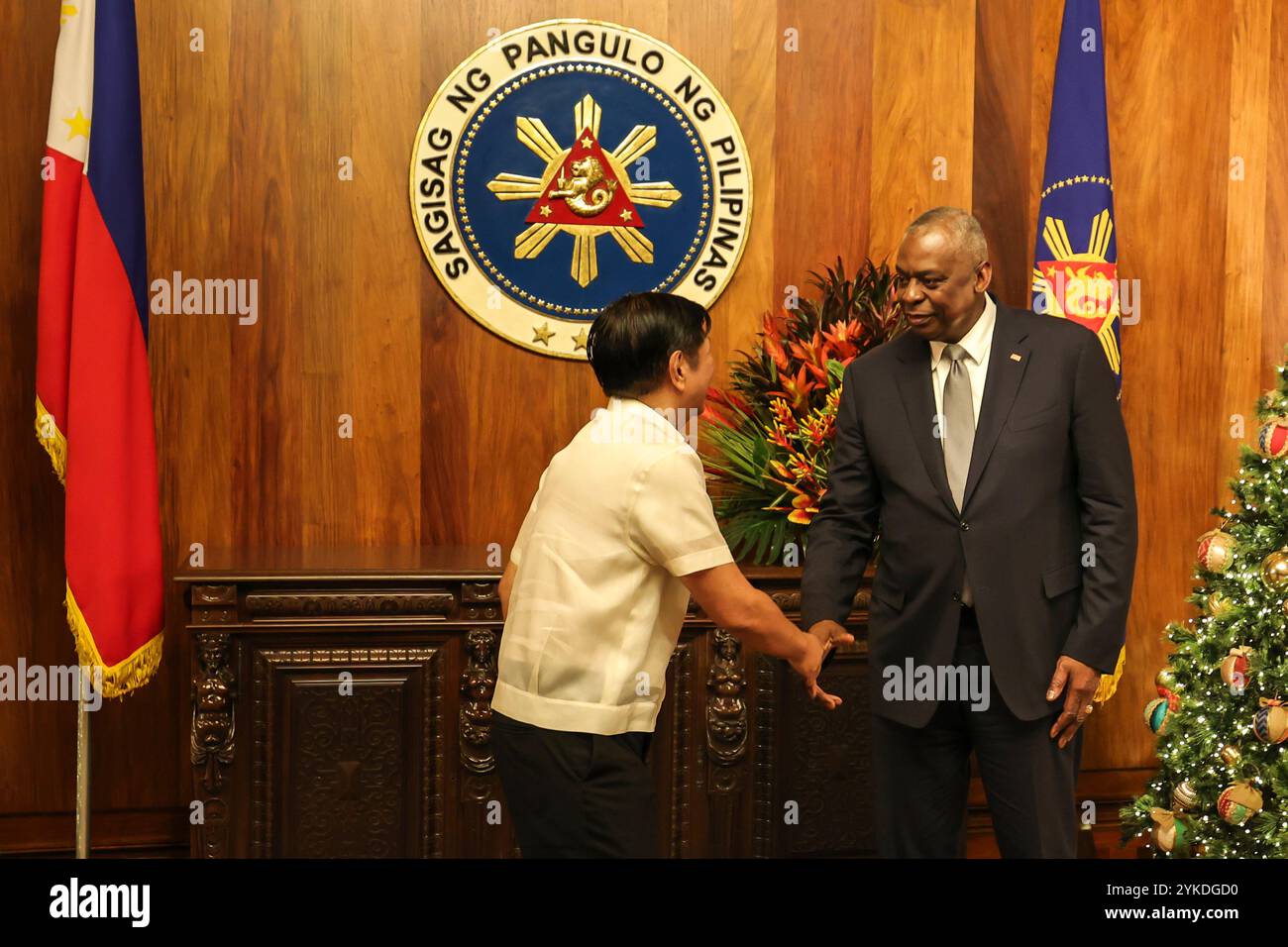 U.S. Defense Secretary Lloyd Austin, right, shakes hands with ...