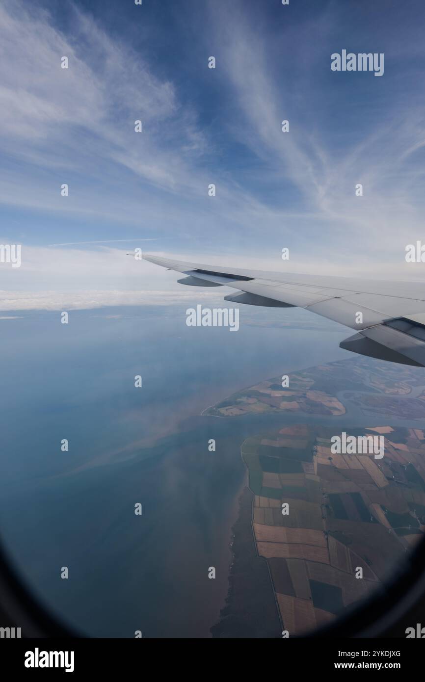 Aerial high-angle view from an airplane, show the sprawling suburbs of ...