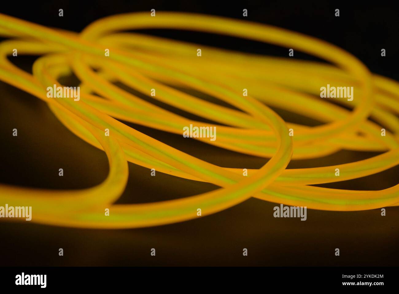 Bright glowing electroluminescent wires, yellow, orange thick light ...