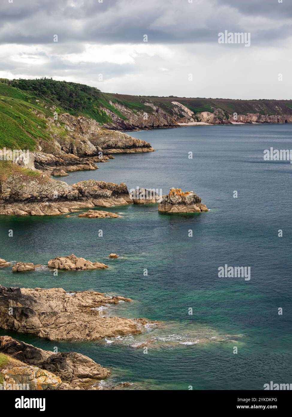 A scenic coastal view in Brittany featuring rocky cliffs and turquoise ...
