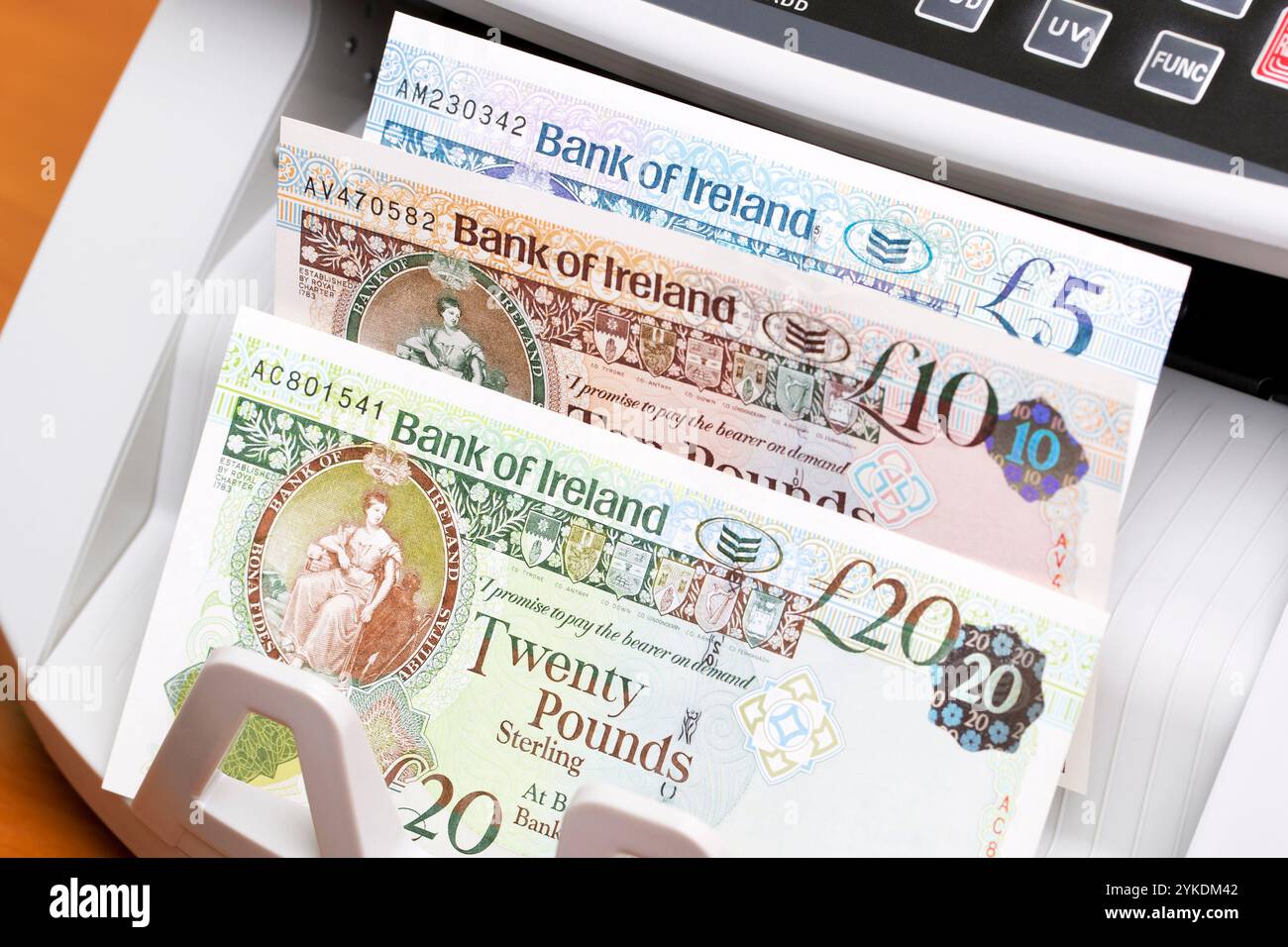 Irish money - pound in the counting machine Stock Photo - Alamy