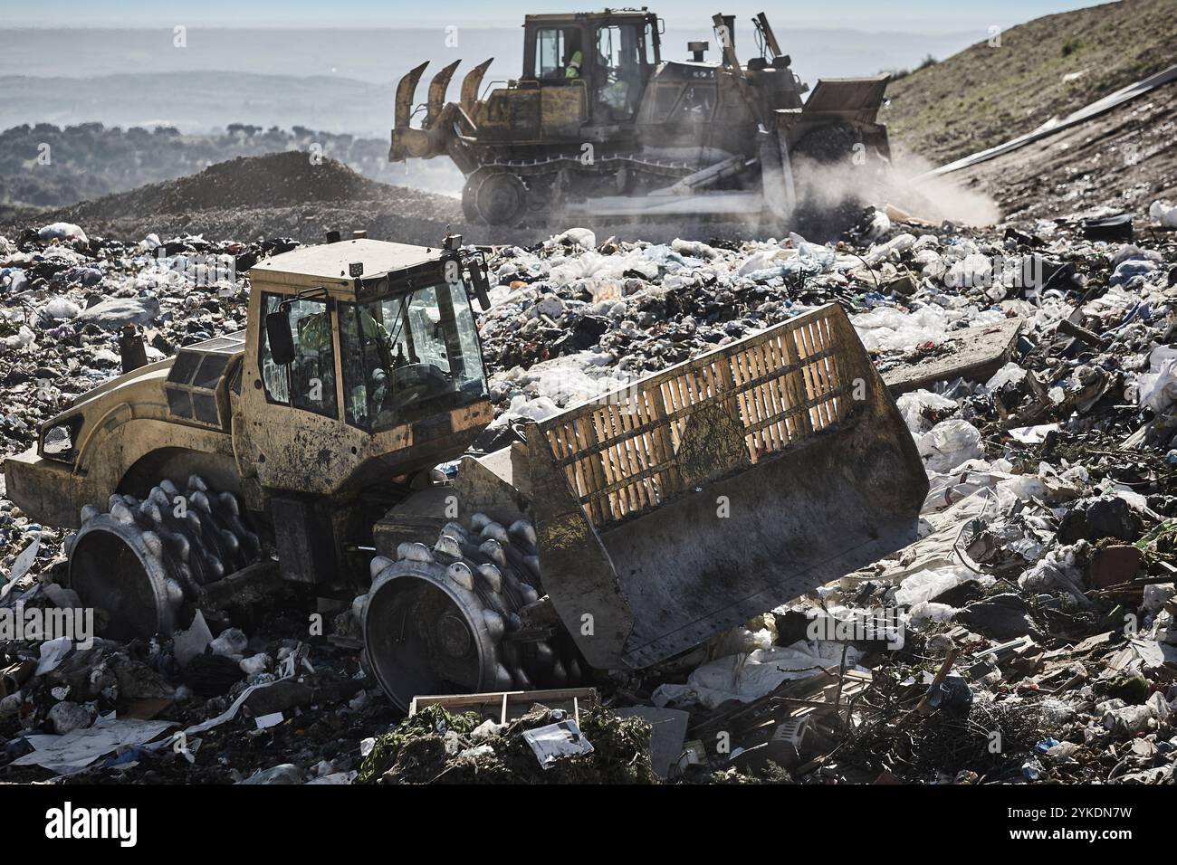 Heavy machinery shredding garbage in an open air landfill. Waste Stock ...