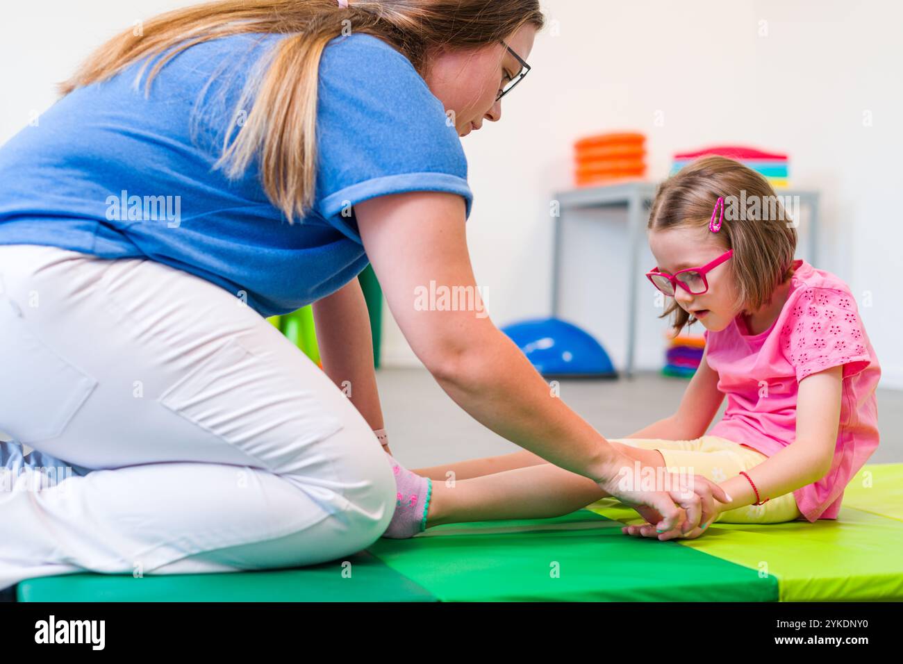 Child with physical disability in physical therapy session. Child ...