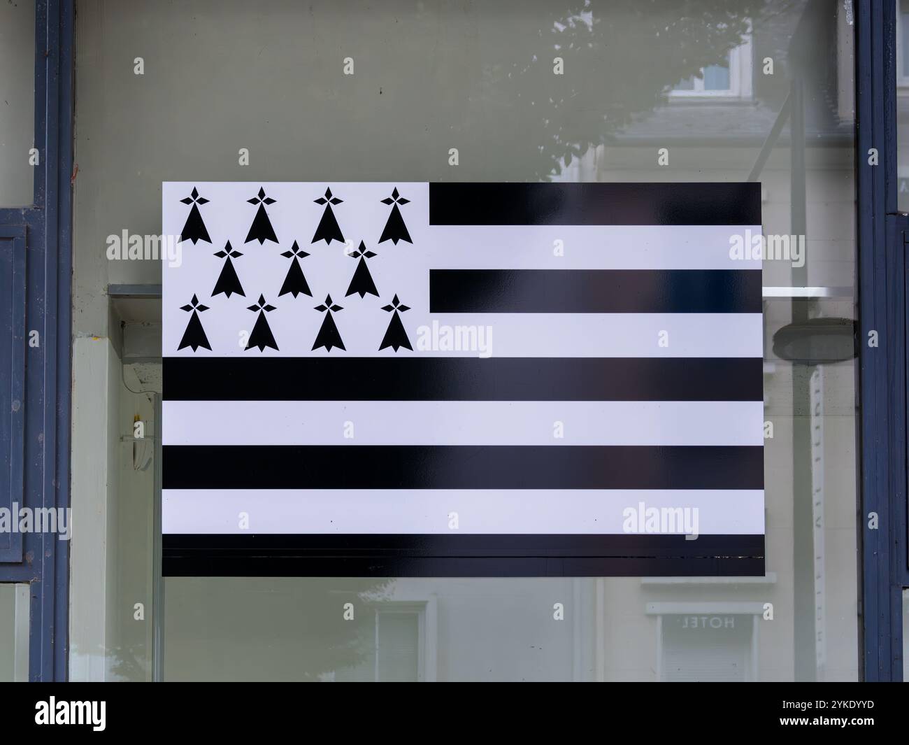 Rennes, France - July 26, 2024: A flag displayed in a window with black ...