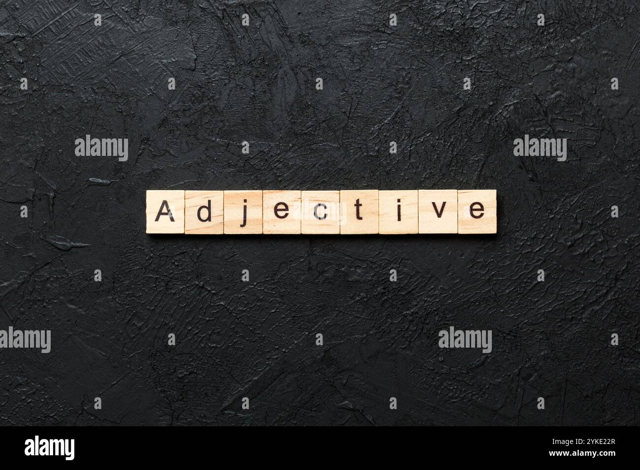 adjective word written on wood block. adjective text on cement table ...