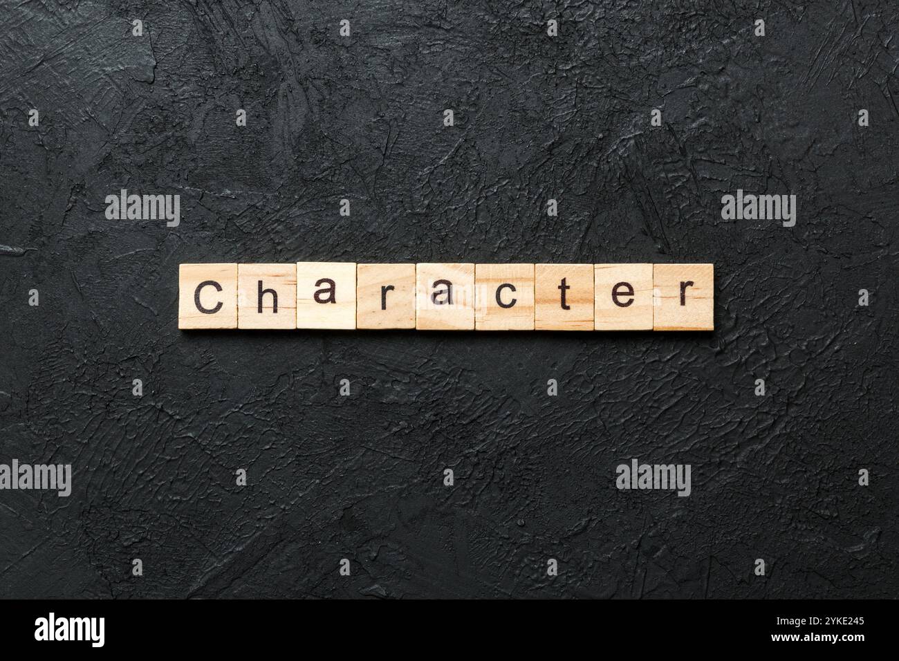 CHARACTER word written on wood block. CHARACTER text on cement table ...