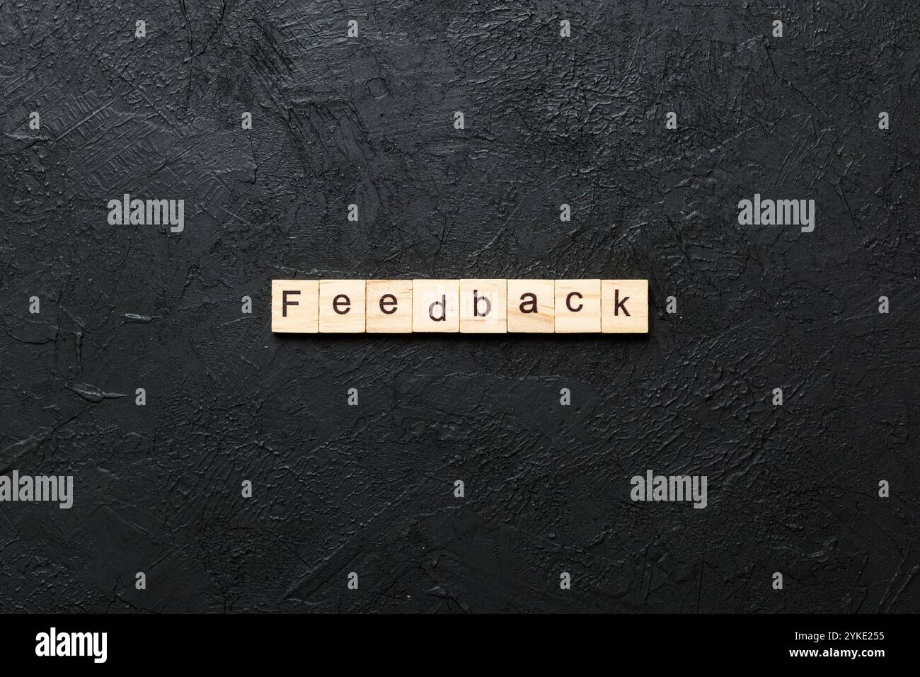 feedback word written on wood block. feedback text on cement table for ...