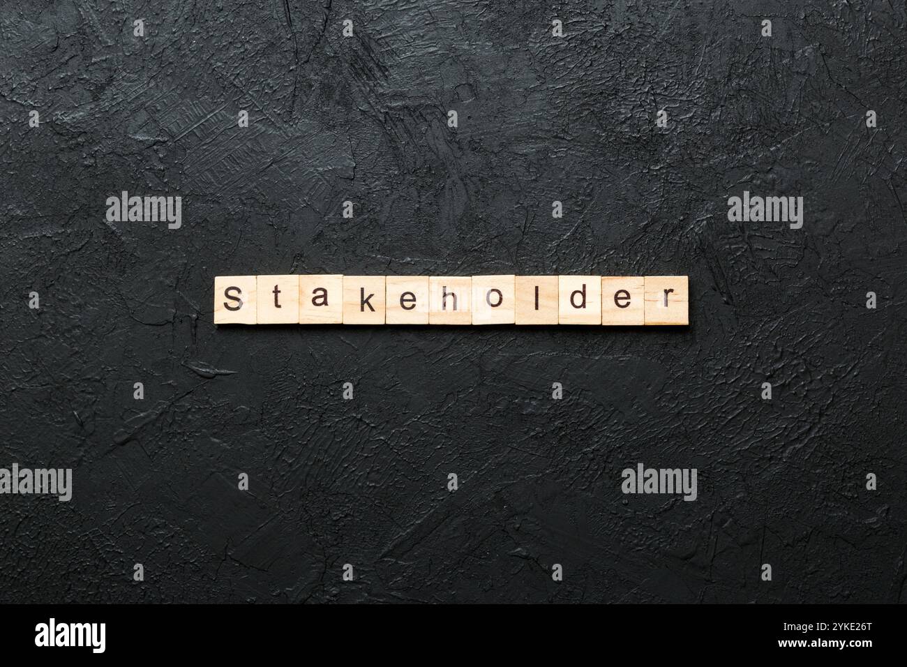 Stakeholder word written on wood block. Stakeholder text on cement table for your desing ...