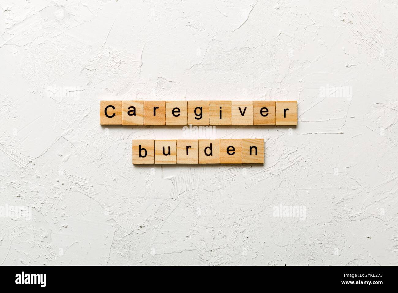 Caregiver burden word written on wood block. Caregiver burden text on ...