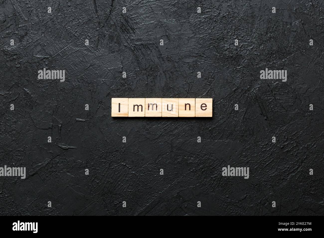 Immune word written on wood block. Immune text on cement table for your ...