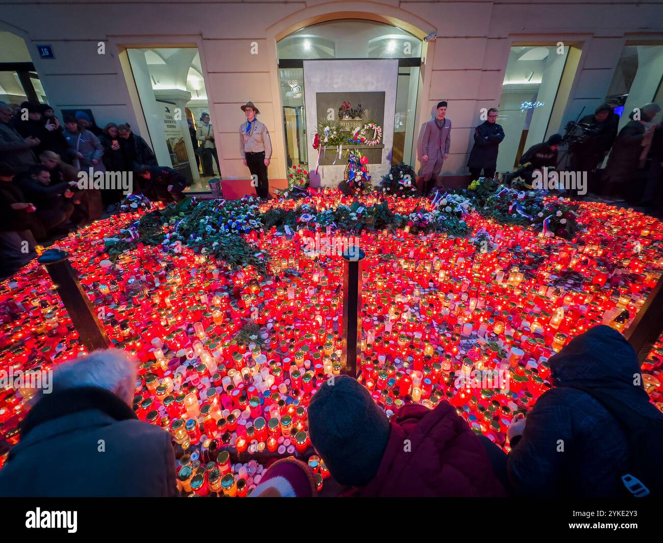 People light candles below the memorial plaque marking the November ...