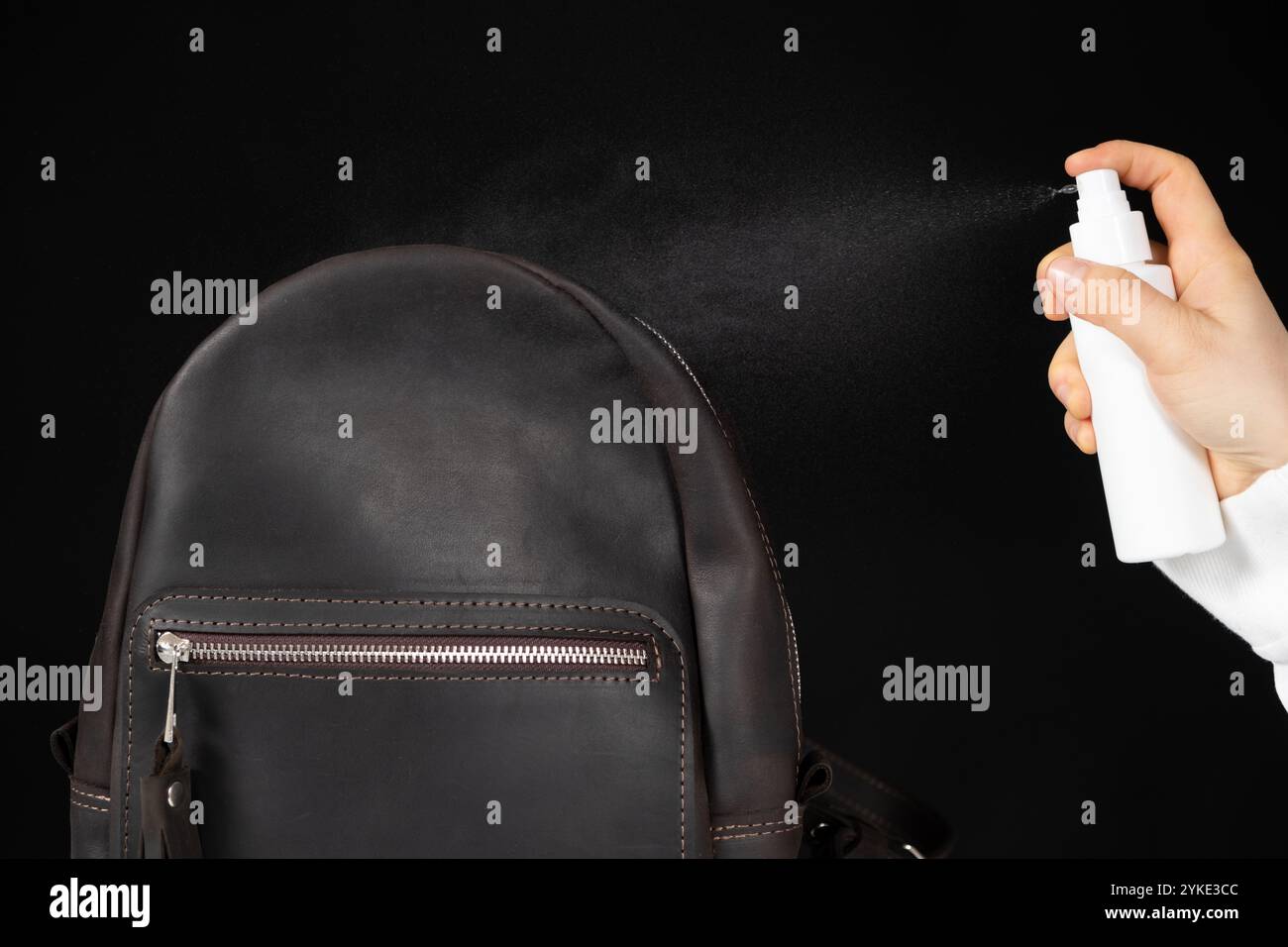 Applying spray leather backpack accessories hi-res stock photography ...
