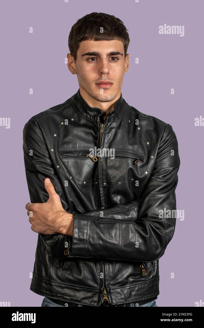 Studio shot of fashionable young man wearing black leather jacket ...