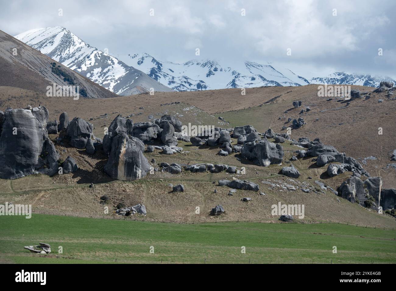 Limestone boulders with snow-covered mountains, Castle Hill, near ...
