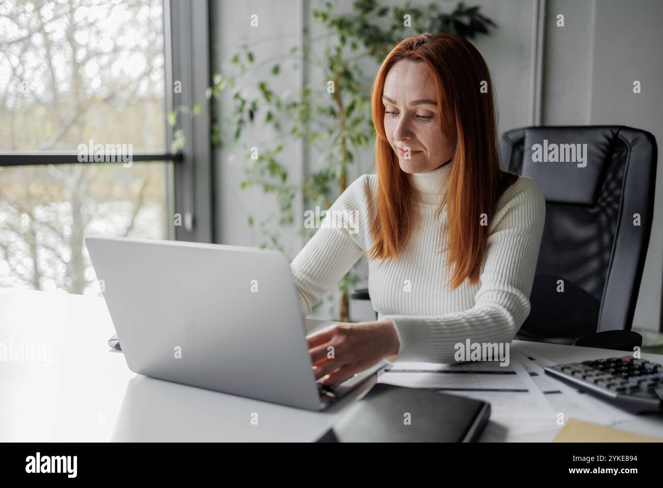 Focused freelancer working paperwork laptop hi-res stock photography ...