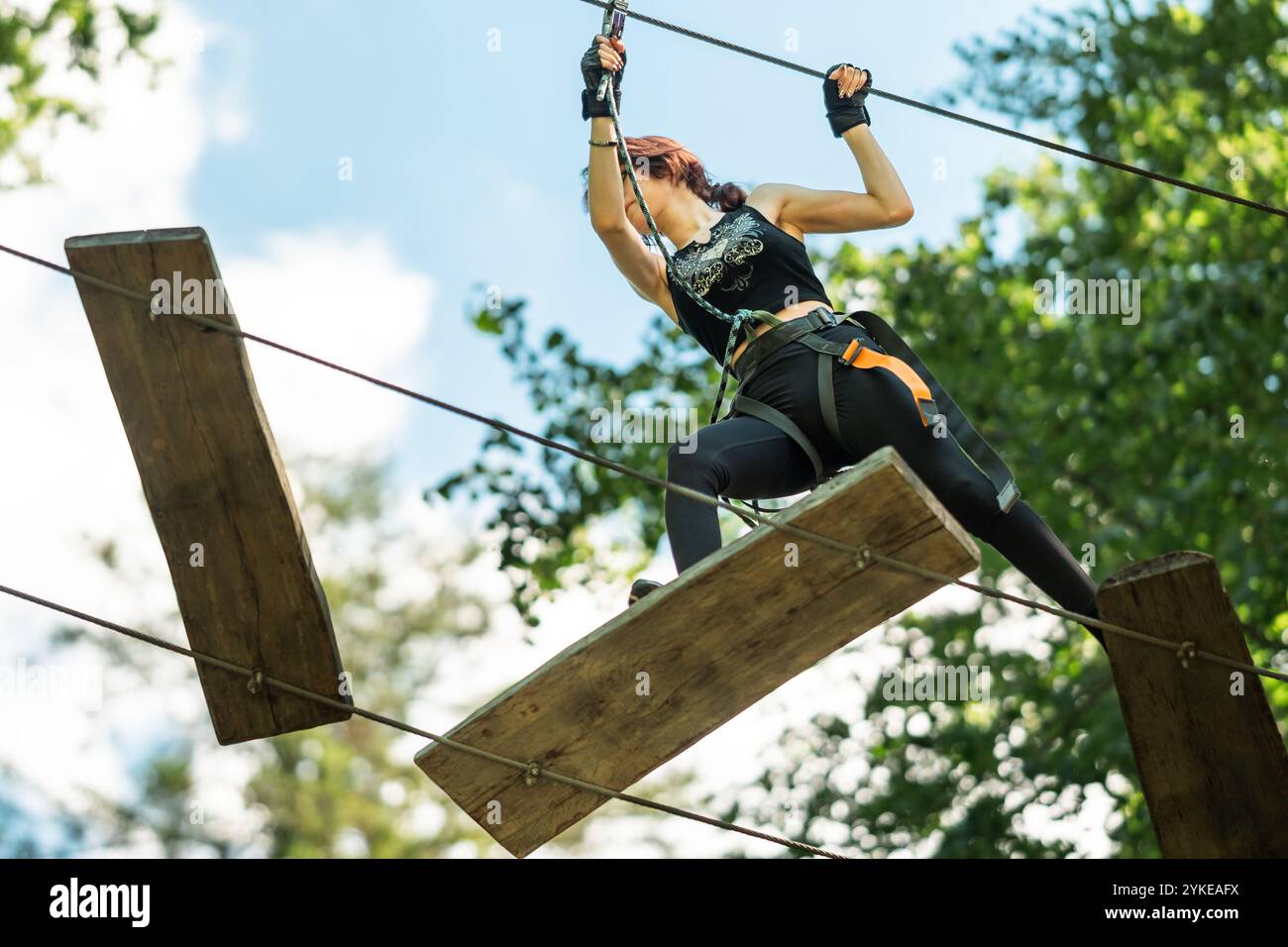 A determined woman successfully conquers the challenging high rope ...