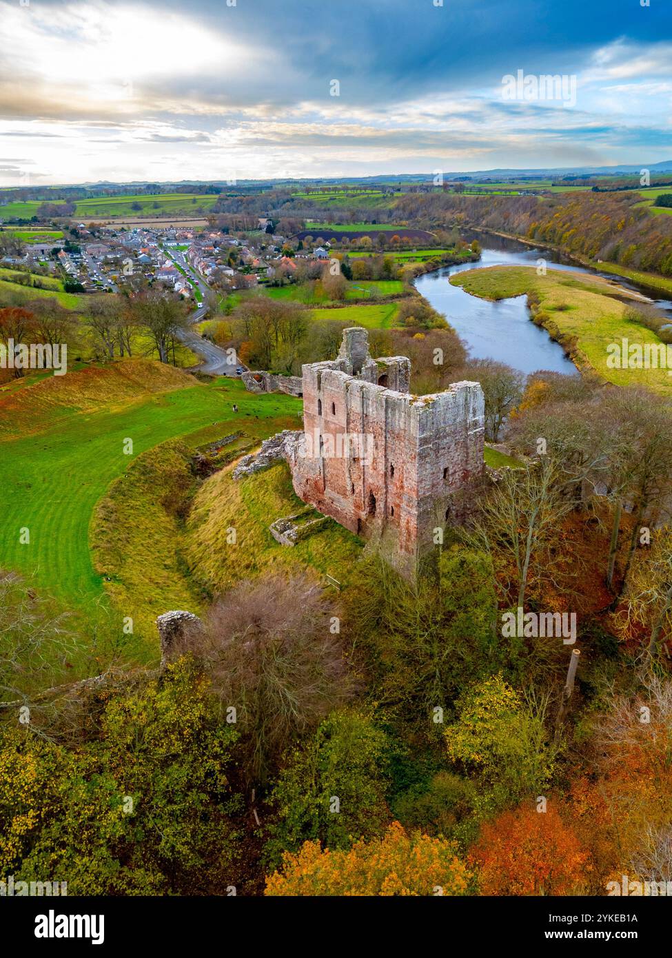 Aerial view of village of Norham and Norham Castle beside River Tweed ...