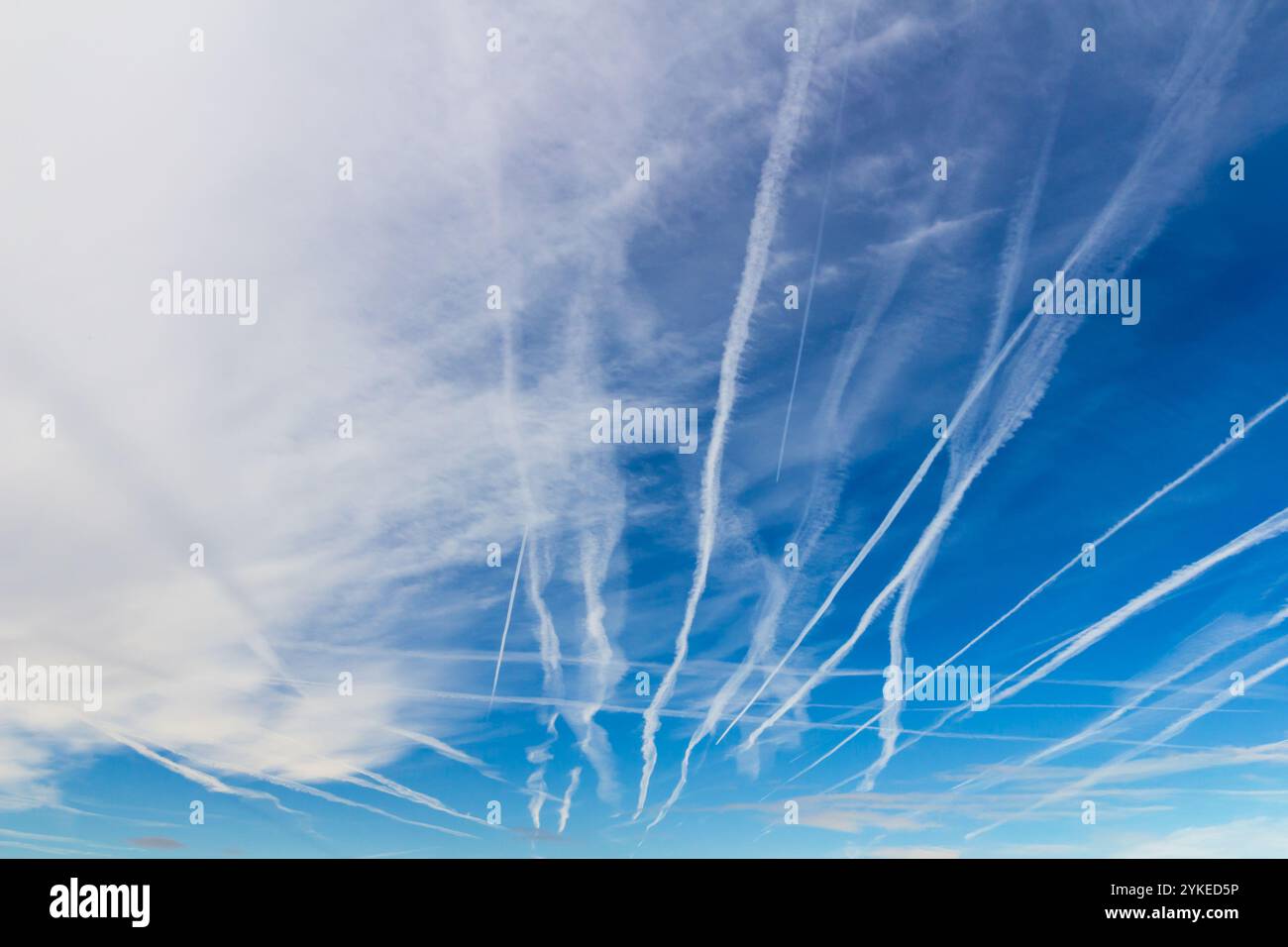 Airplane aircraft contrails in blue sky, air pollution, overtourism ...