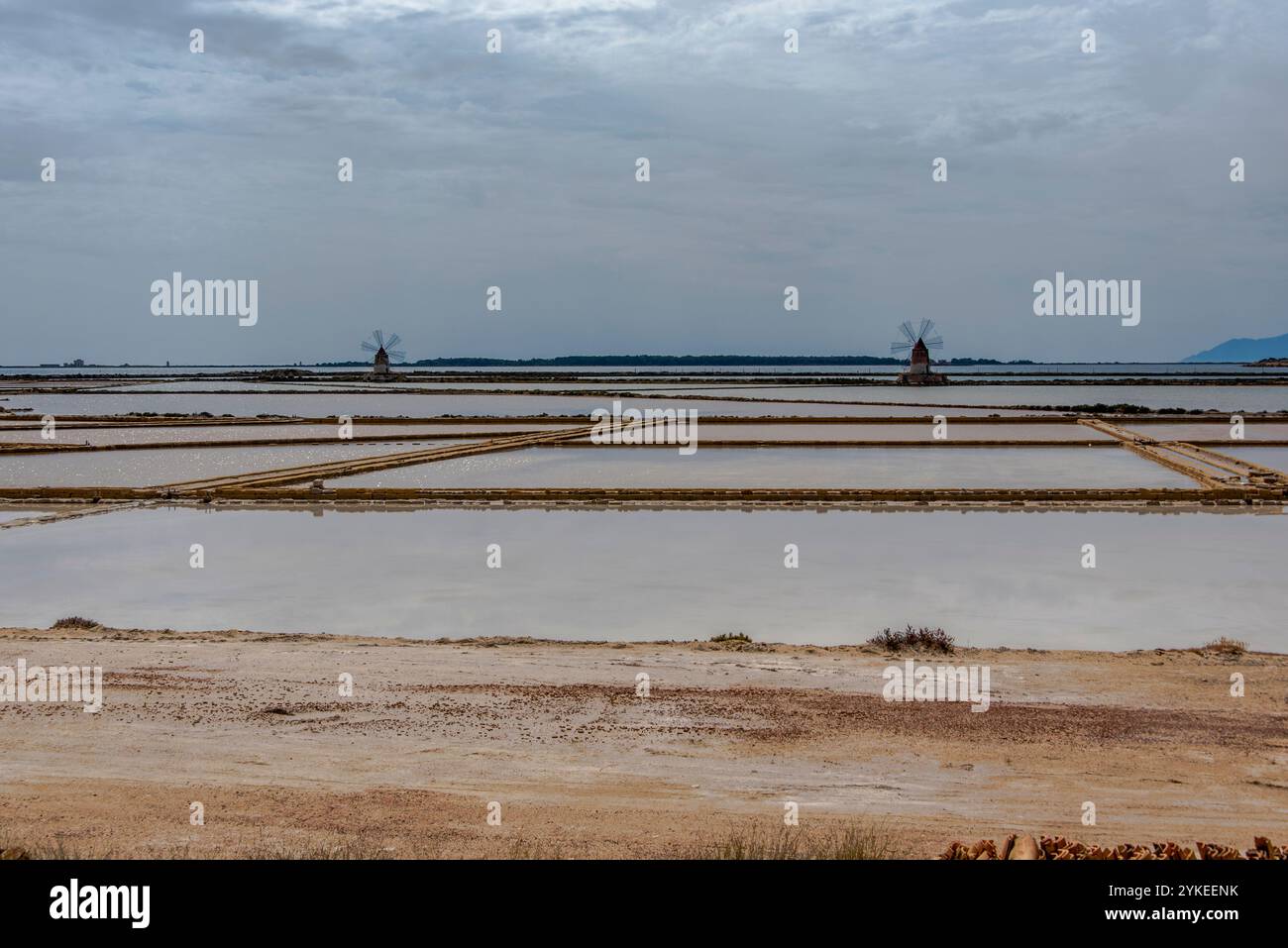 the Saline di Marsala in the Stagnone lagoon with old windmills and ...