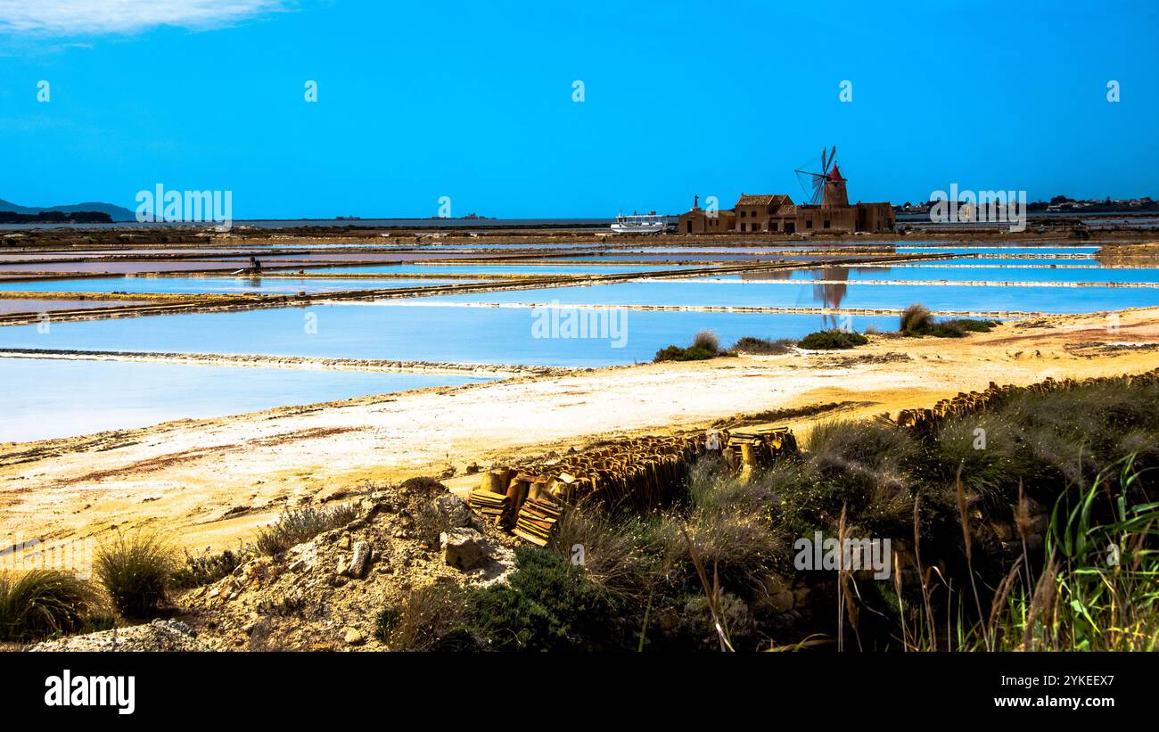 the Saline di Marsala in the Stagnone lagoon with old windmills and ...