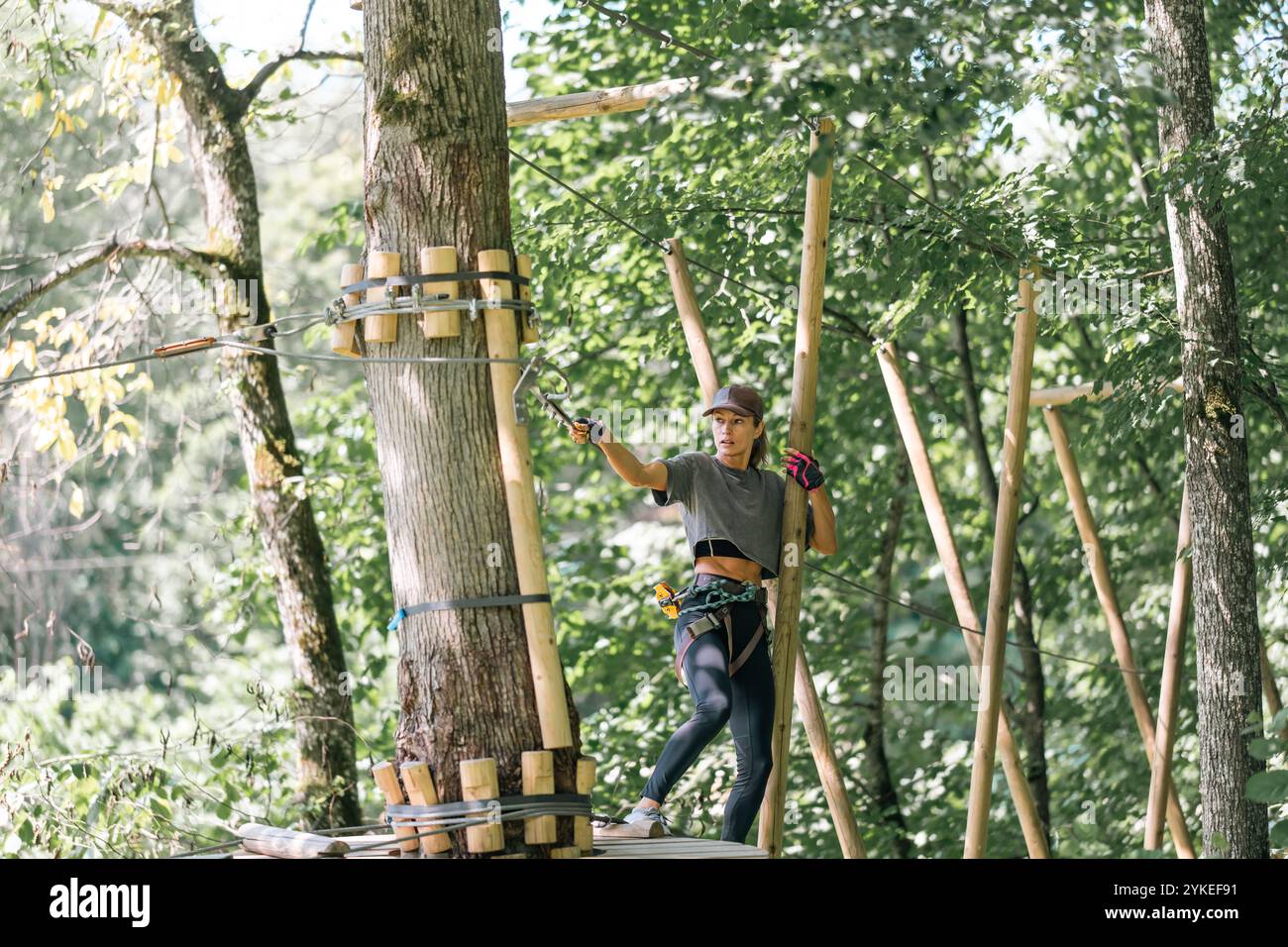 An adventurous climber skillfully navigating challenging ropes and ...