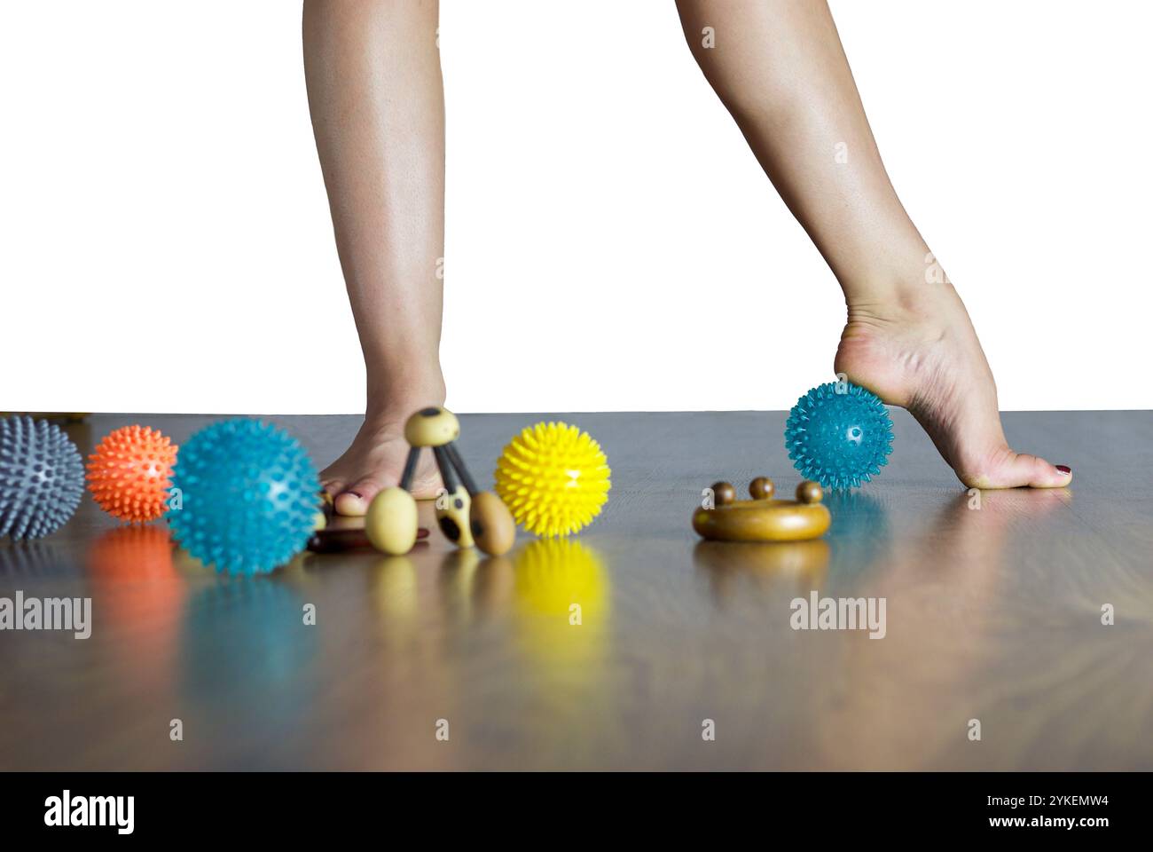 ballet dancer feet with balls for foot massage, wooden floor and white ...