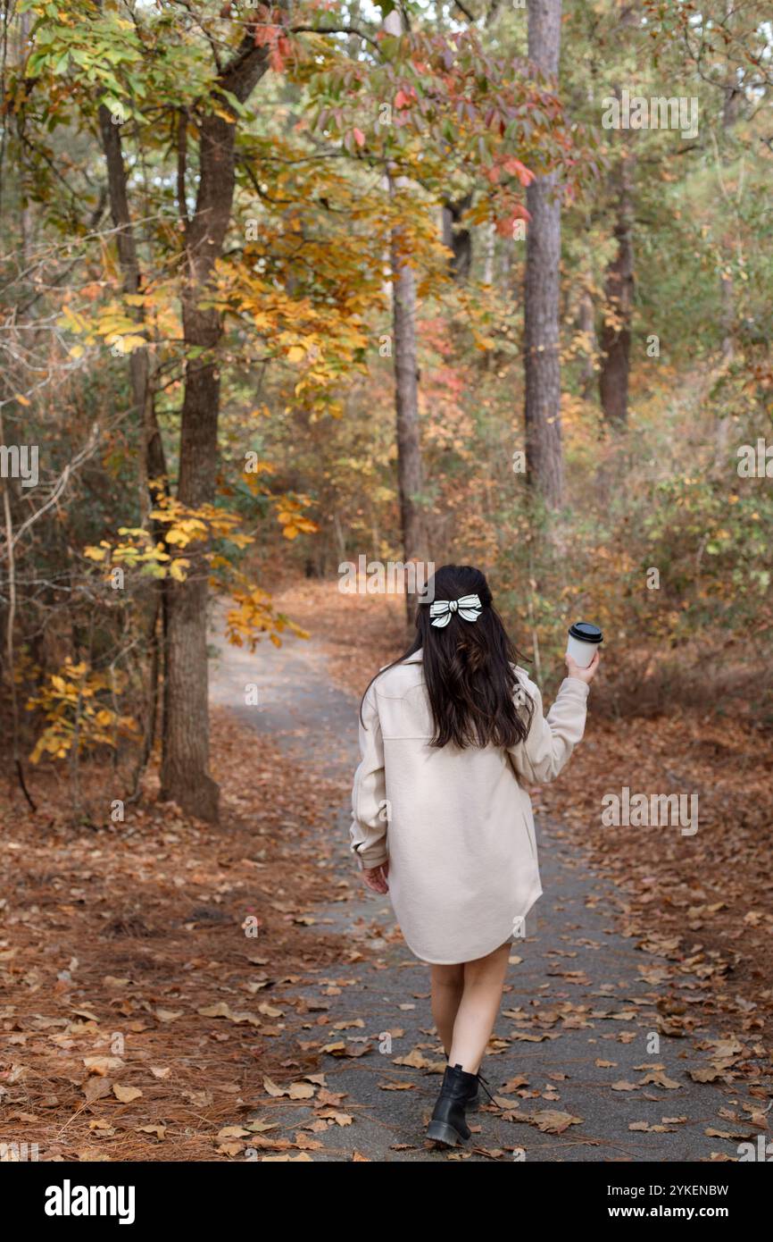 Woman enjoying a Fall walk in the forest Stock Photo - Alamy