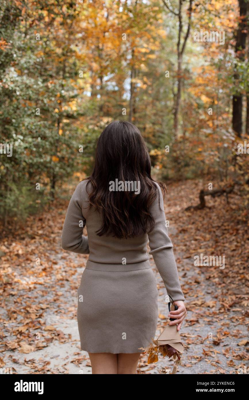 Woman enjoying a Fall walk in the forest Stock Photo - Alamy