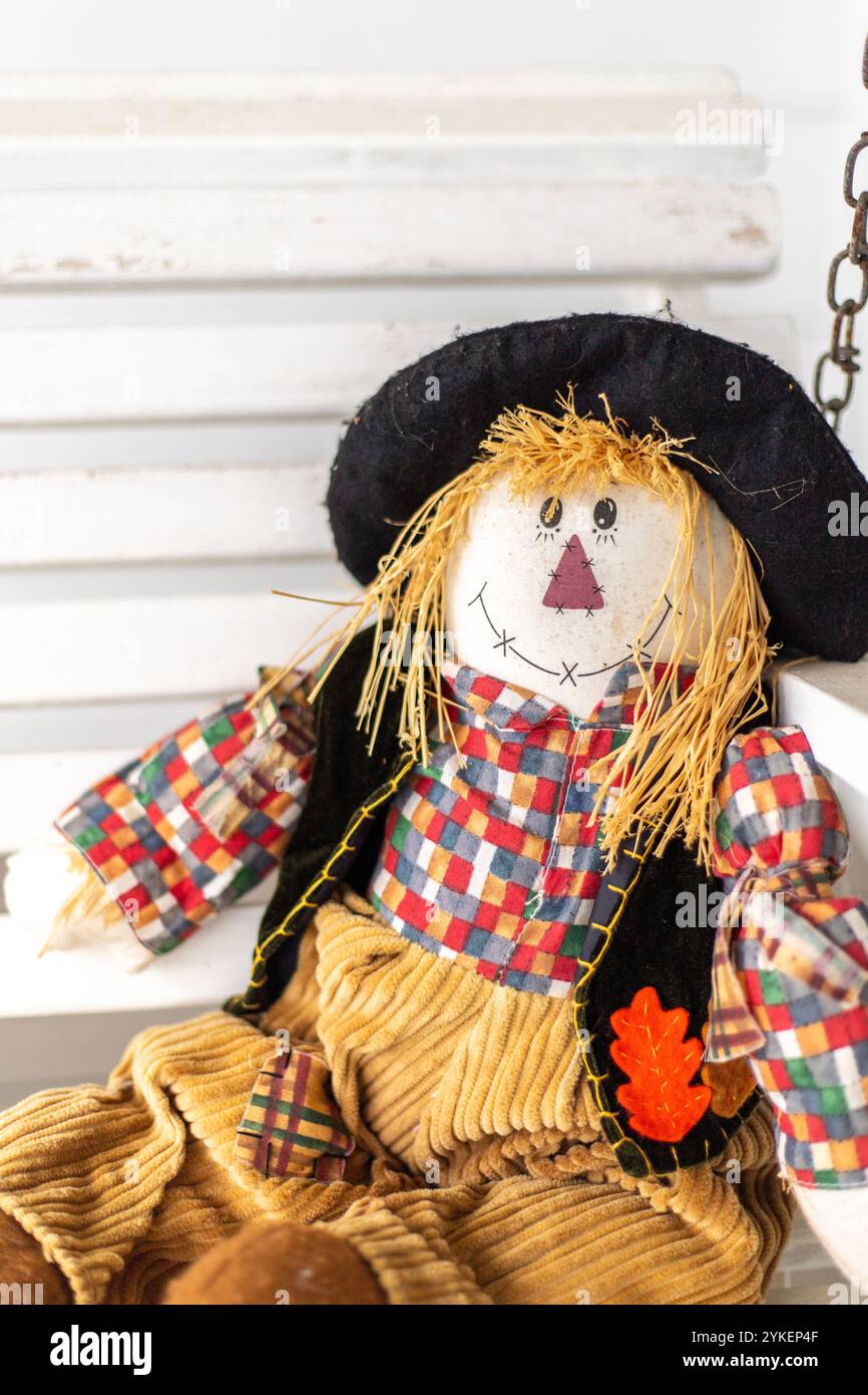Stuffed Scarecrow on White Front Porch Swing Stock Photo - Alamy